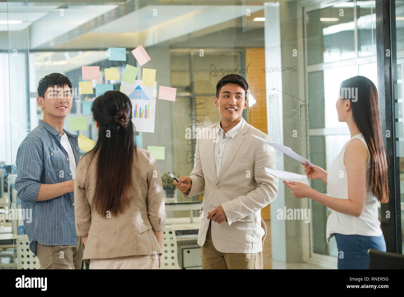 Business young men and women in a meeting Stock Photo - Alamy
