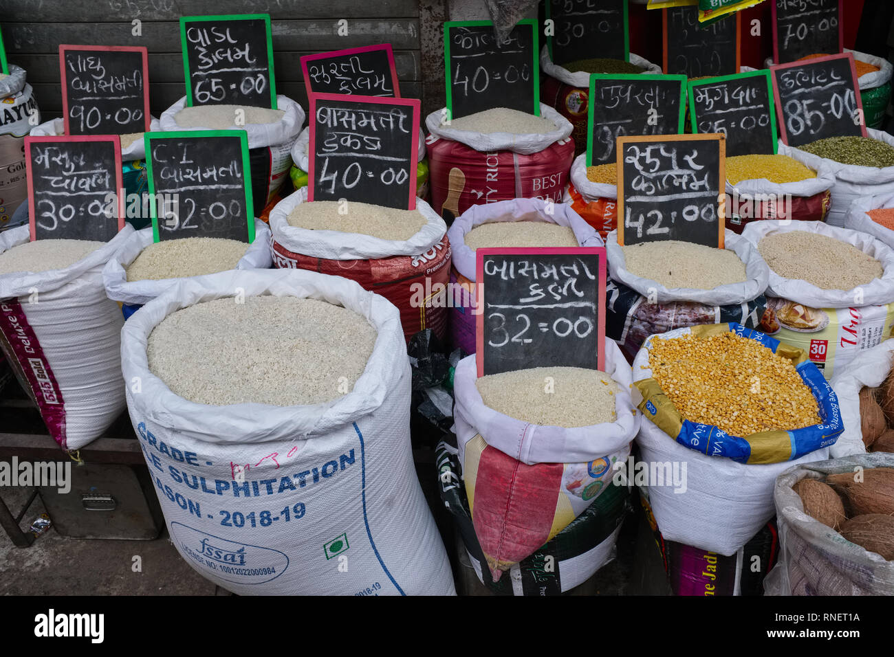 At a grocery store in Mumbai, India, various types of rice and pulses ...