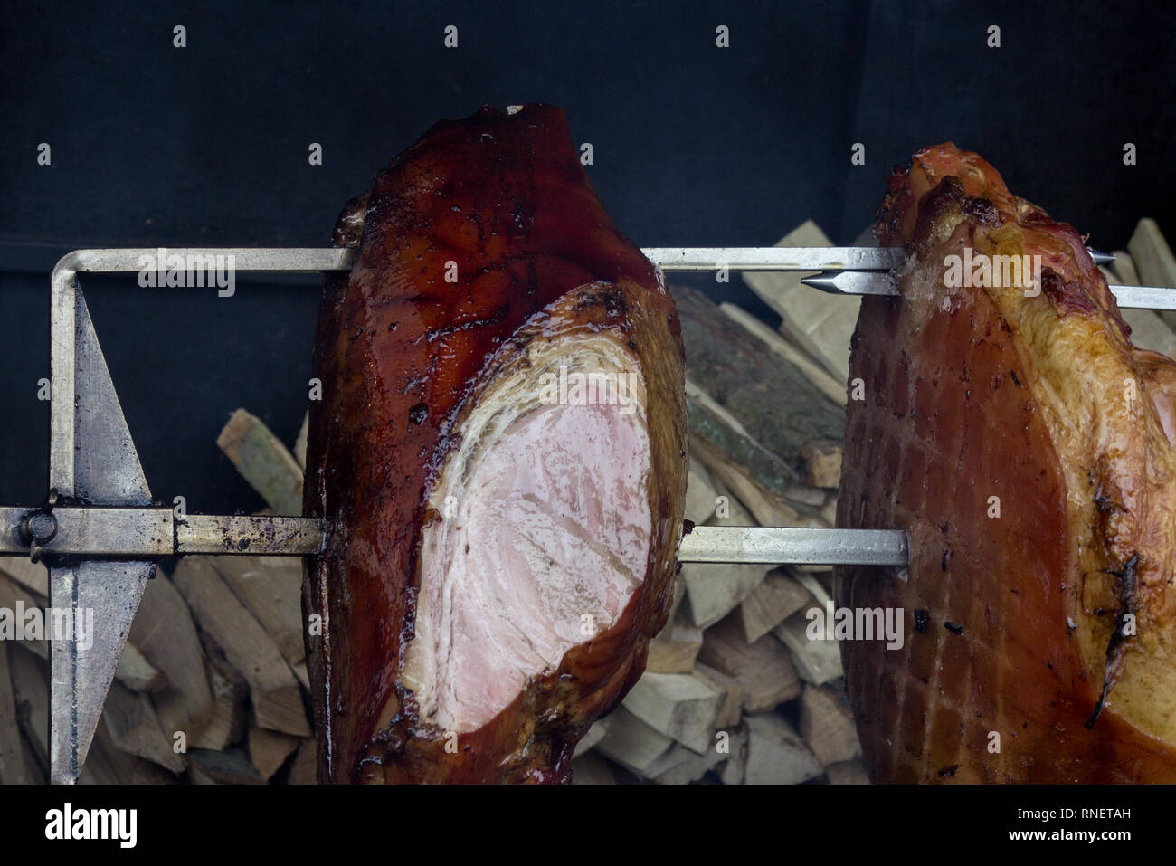 Very good meat on turnspit and wooden logs - street flood Stock Photo ...