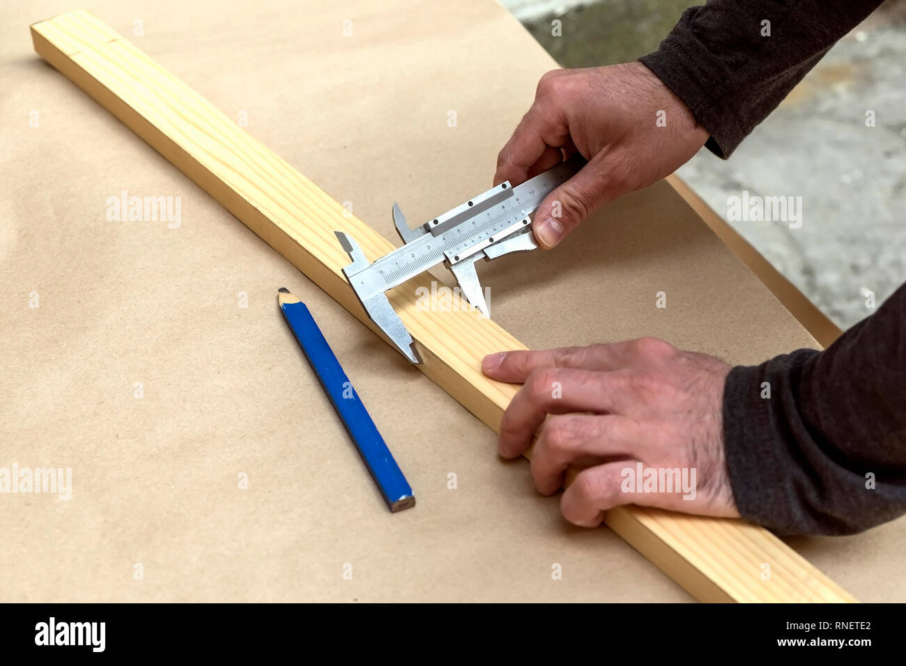 Carpenter measuring wood with caliper Stock Photo - Alamy