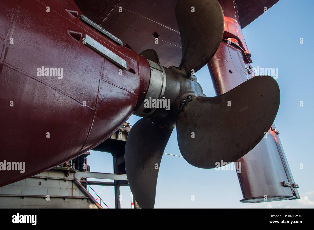 View of ship propeller and rudder in a dry dock background ...