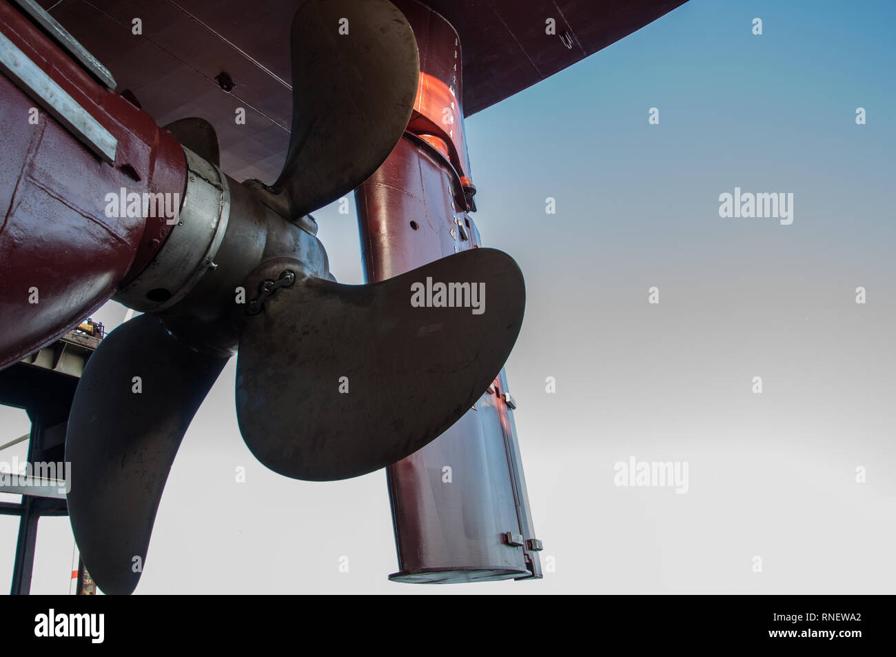 View of ship propeller and rudder in a dry dock background ...