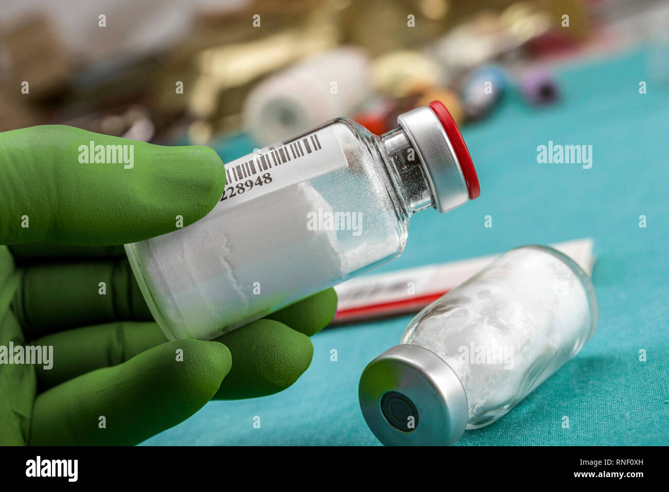 Detail of hand medical holding a vial, conceptual image Stock Photo - Alamy