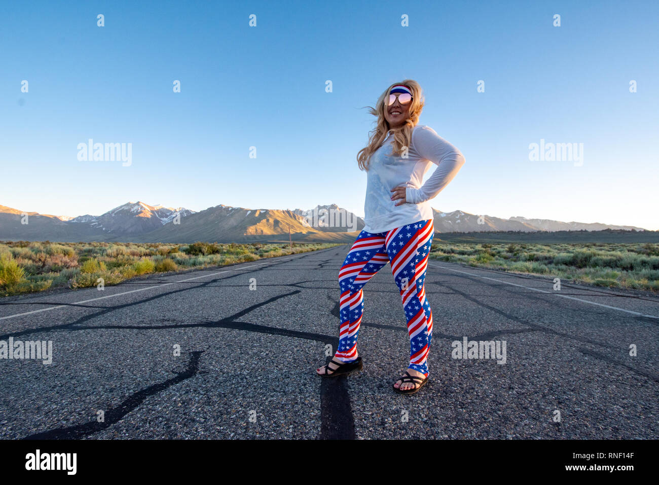 Blonde female wearing patriotic American clothing costume stands in the ...