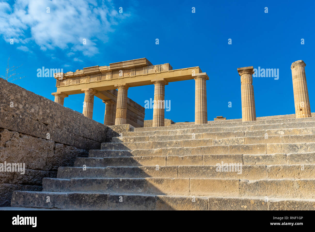View from below from the stairs of ancient Greek pillars of Lindos ...