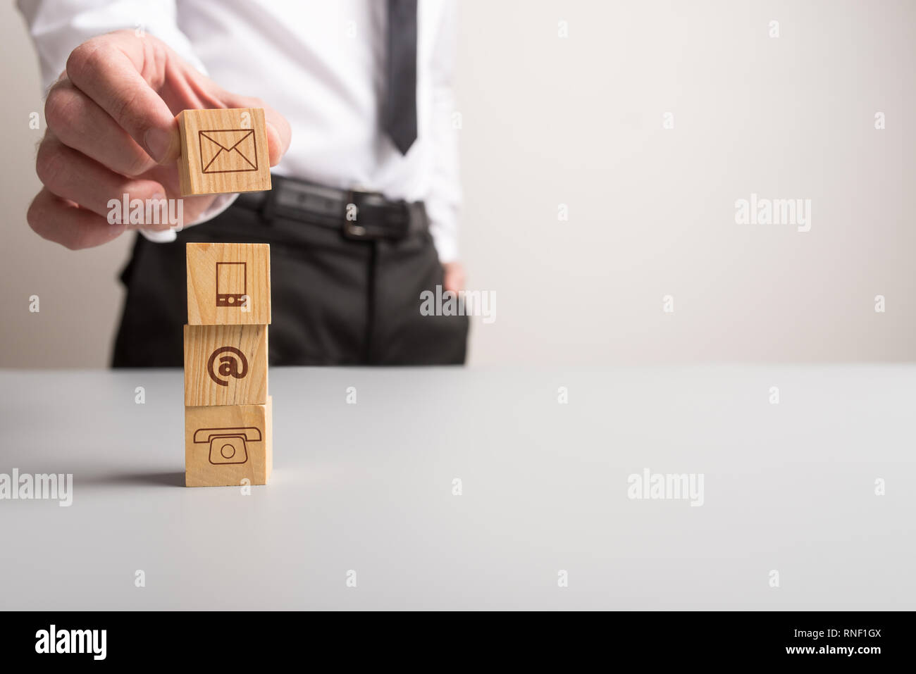 Customer service and support concept - businessman placing wooden ...