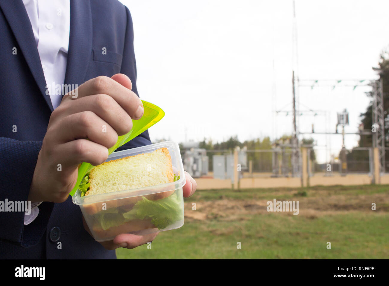 Male chief engineer snacks in the workplace, energy, proper nutrition ...