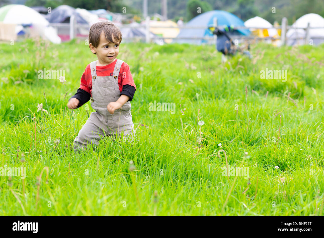 Lovely boy enjoying outdoors, natural green background Stock Photo - Alamy