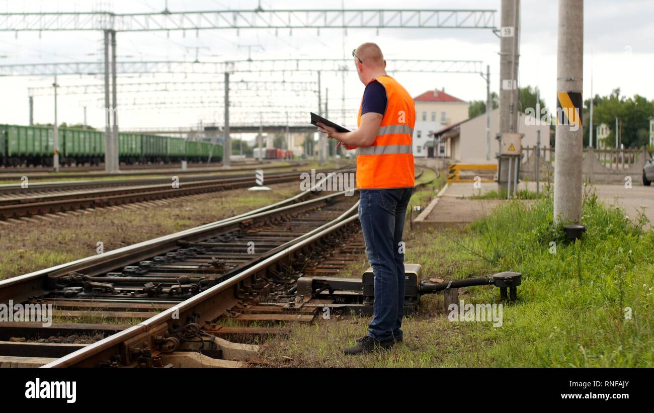 Inspector inspects checks the automatic switch mechanism on the railway ...
