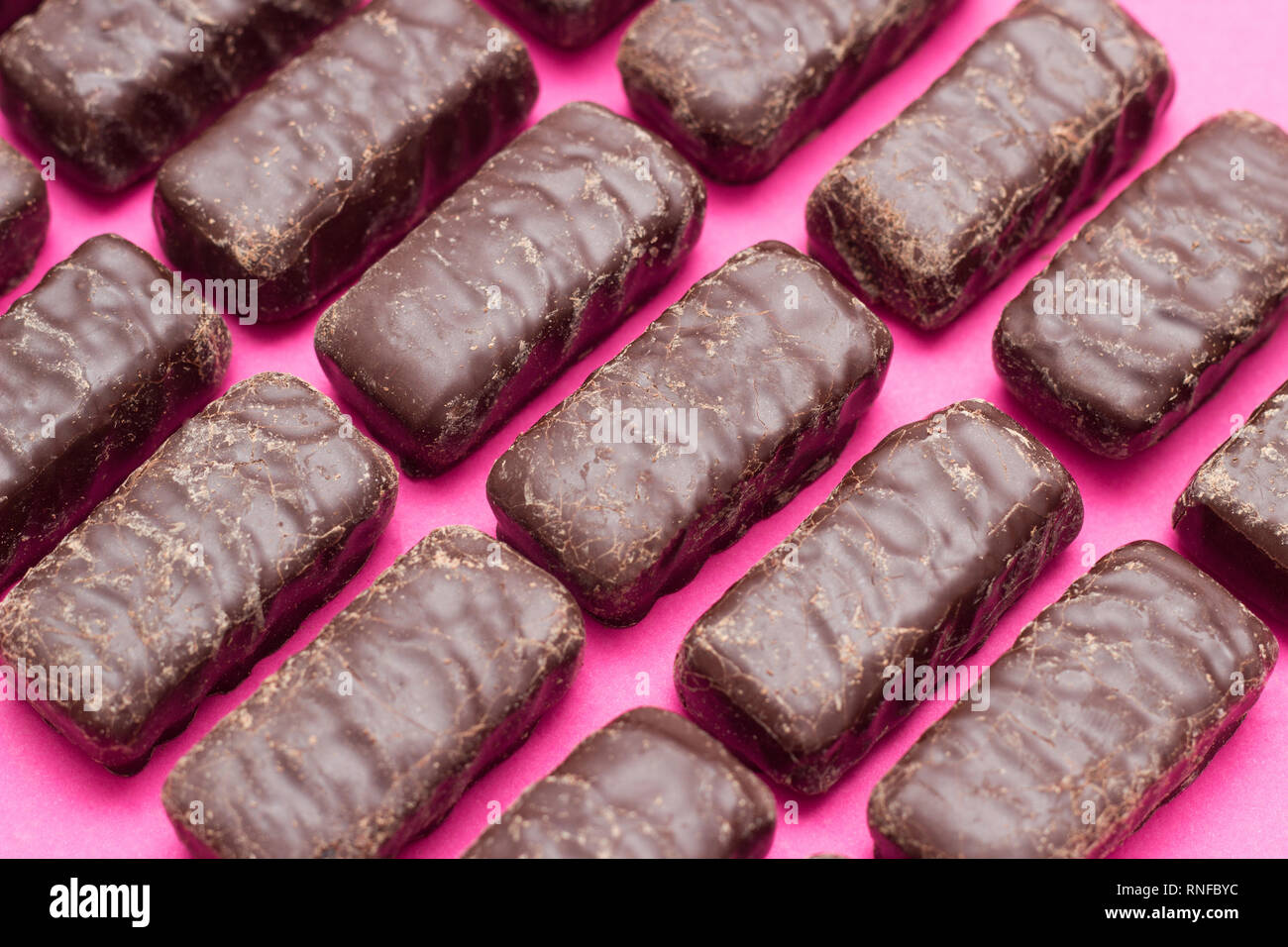a lot of chocolates on a pink background, the background of chocolates ...