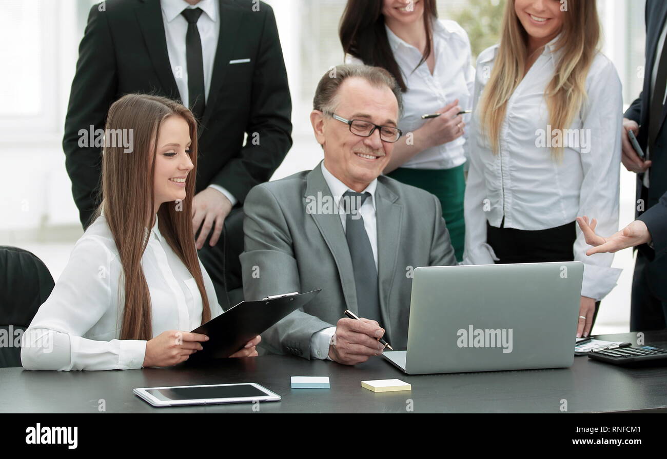 Director and business team looking at laptop screen Stock Photo - Alamy