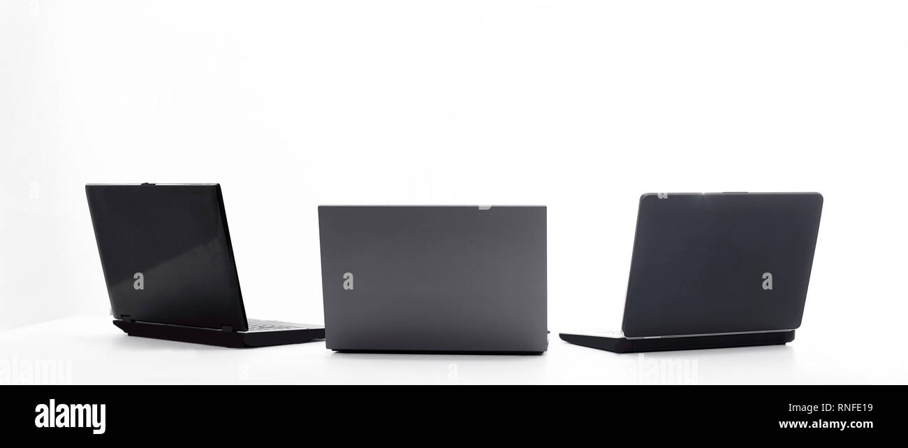 three open laptop in the workplace .isolated on white Stock Photo - Alamy