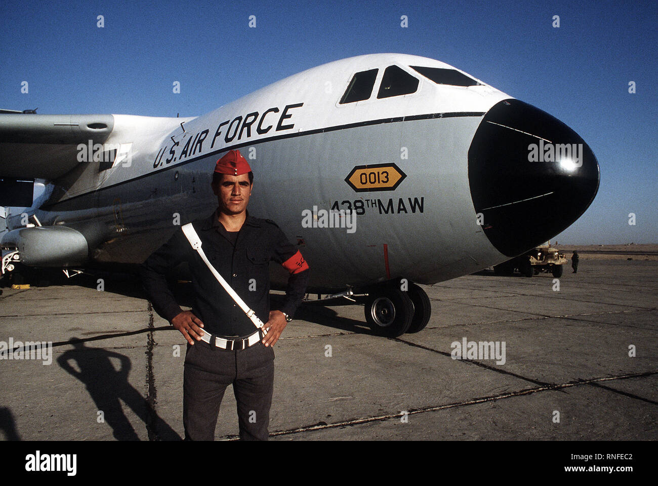 An Egyptian man stands in front of a C-141 Starlifter aircraft while ...