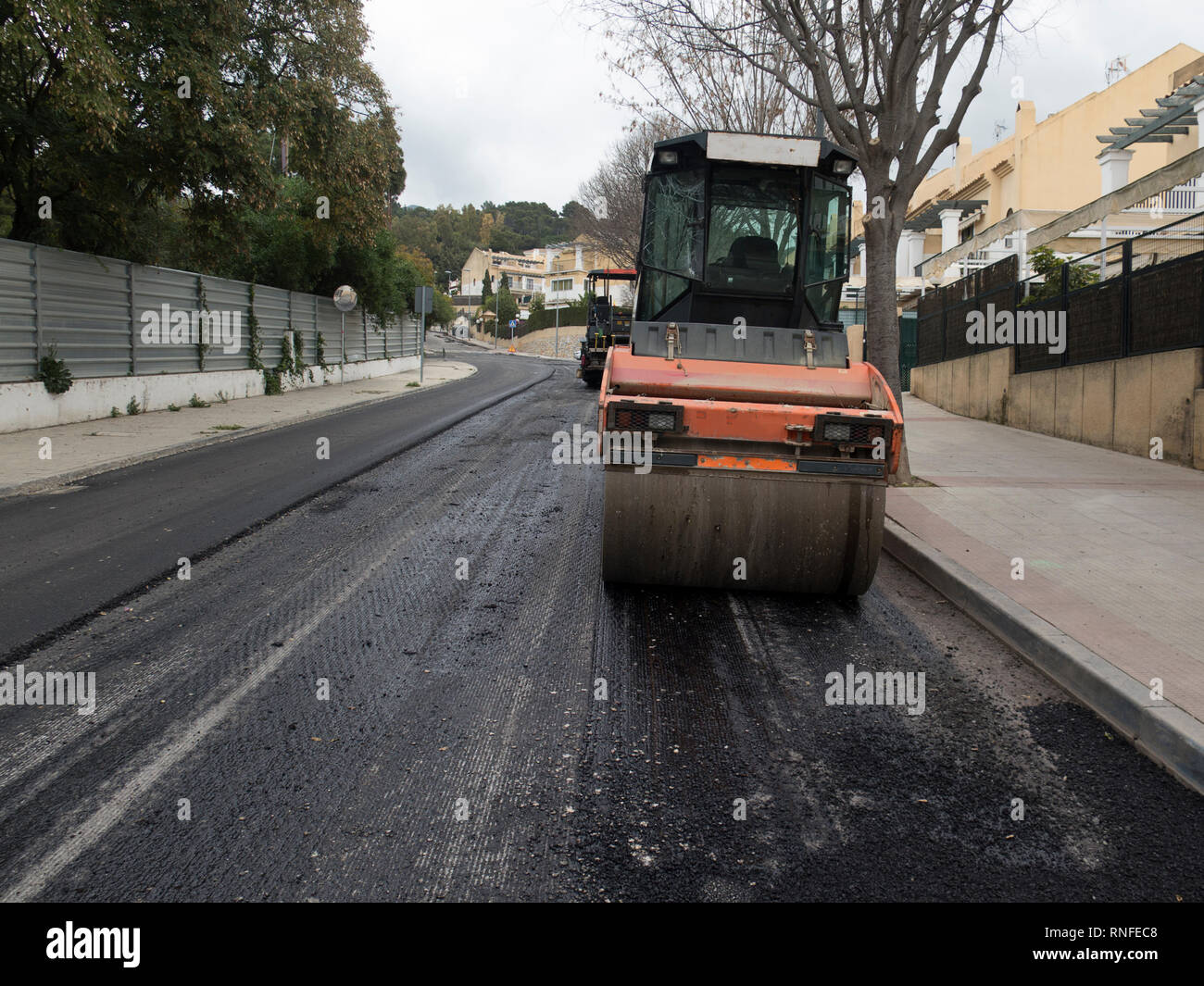 Modern heavy asphalt roller stacking and press hot asphalt. Orange road ...