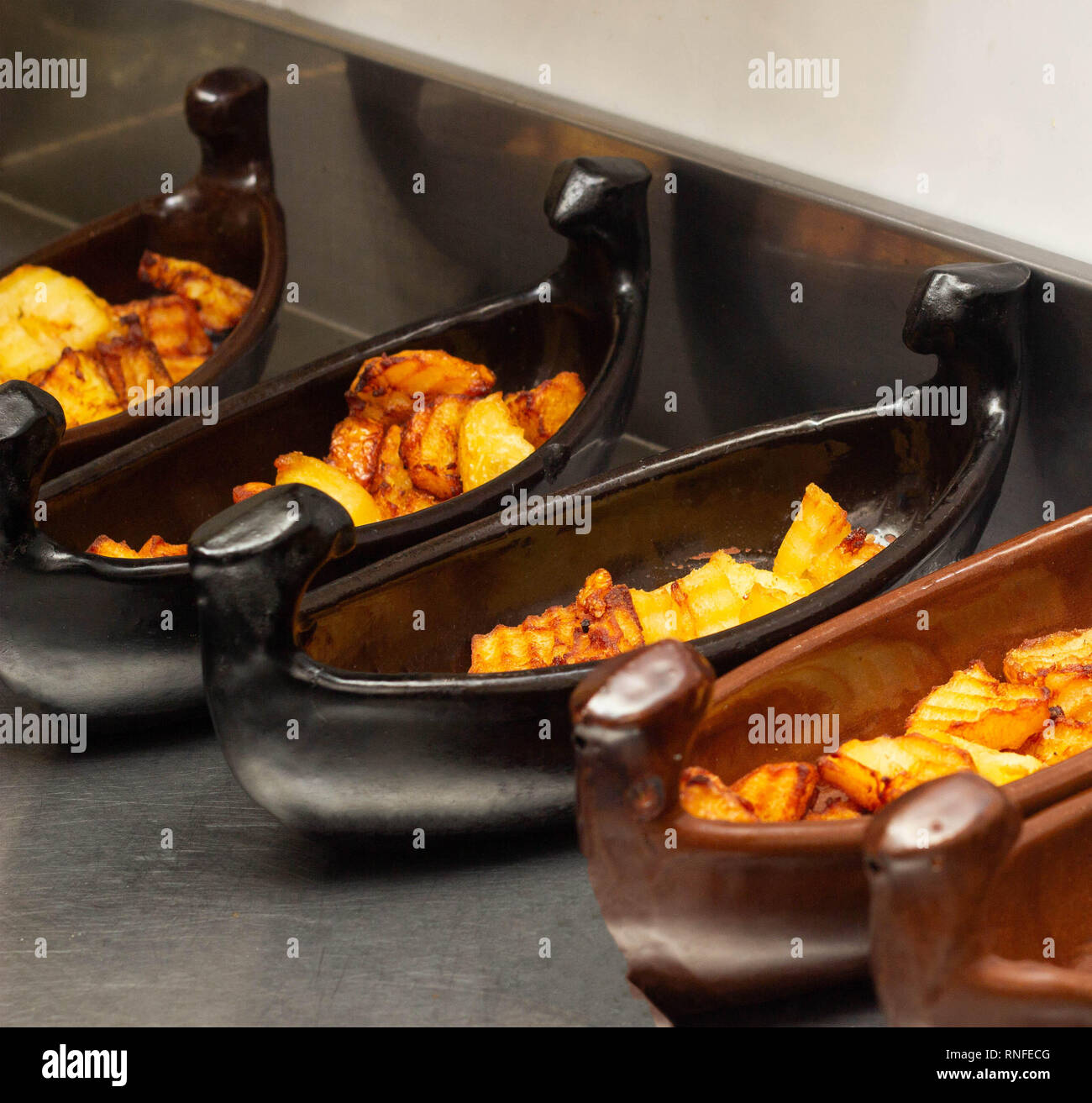 Restaurant dish of boat with fried potatoes in fryer, close-up, shallop ...