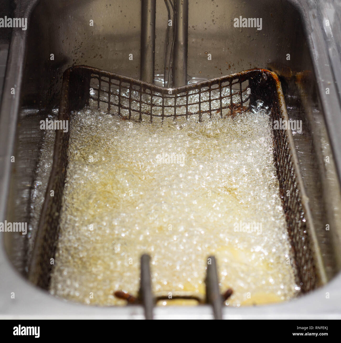 Boiling and boiling oil in which fries are fried and rustic in a fast ...