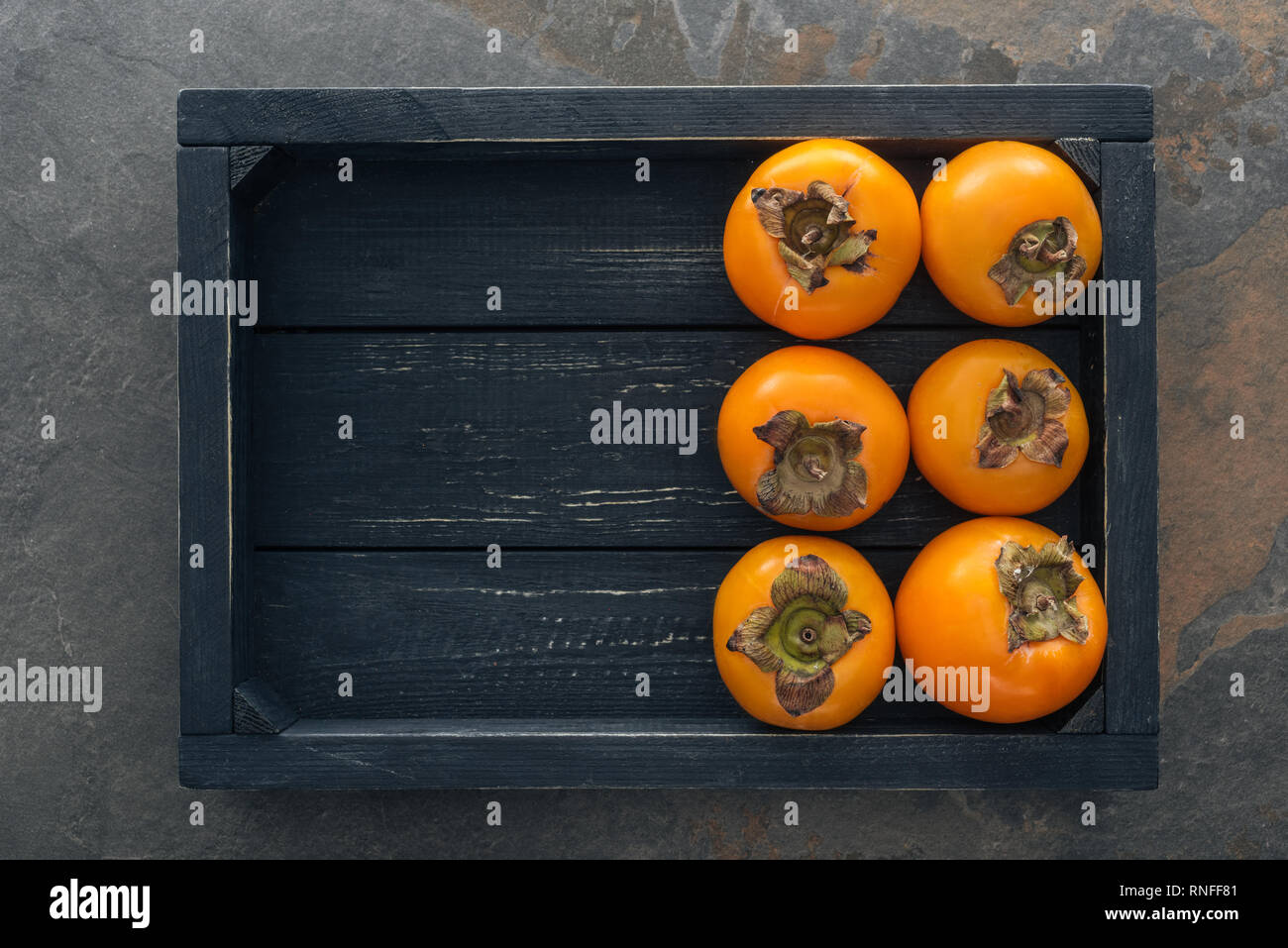top view of whole persimmons in black box with copy space Stock Photo ...