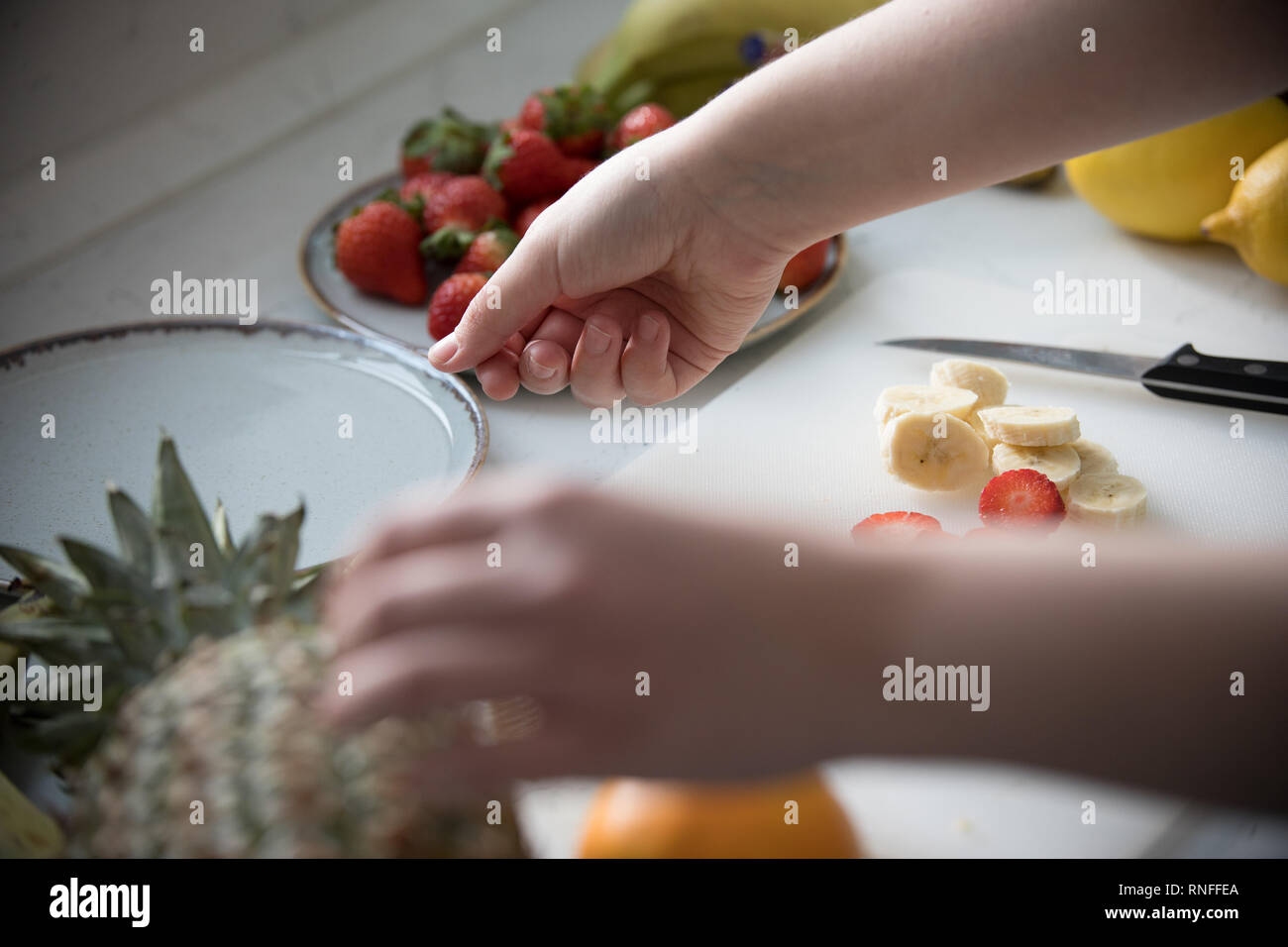 A person serving a dessert with fresh fruits Stock Photo - Alamy