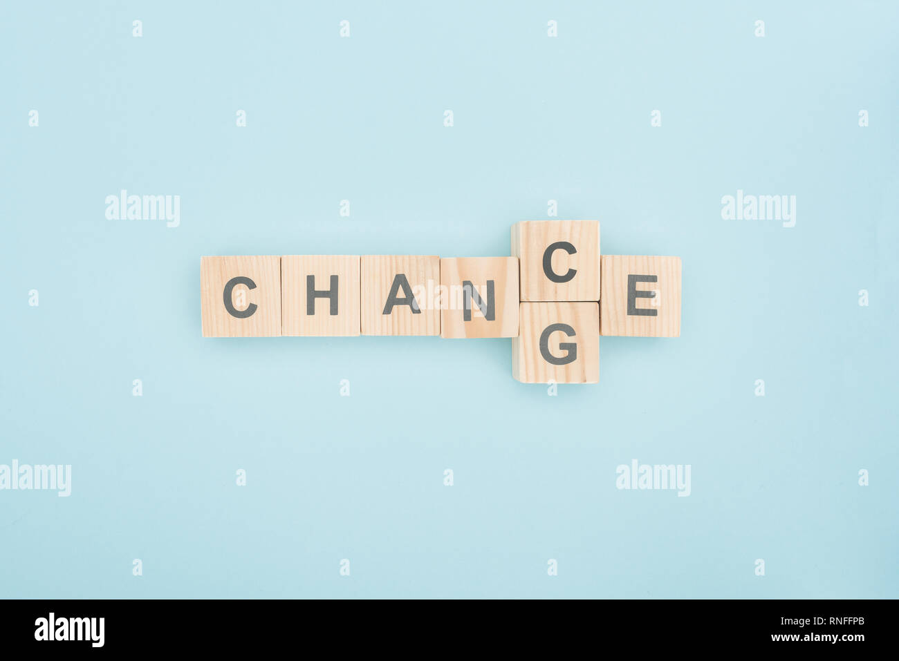 top view switching chance to change lettering made of wooden blocks on ...