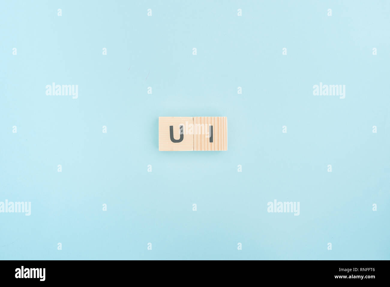 top view of ui lettering made of wooden cubes on blue background Stock ...