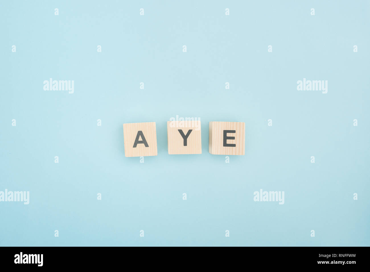 top view of aye lettering made of wooden cubes on blue background Stock ...