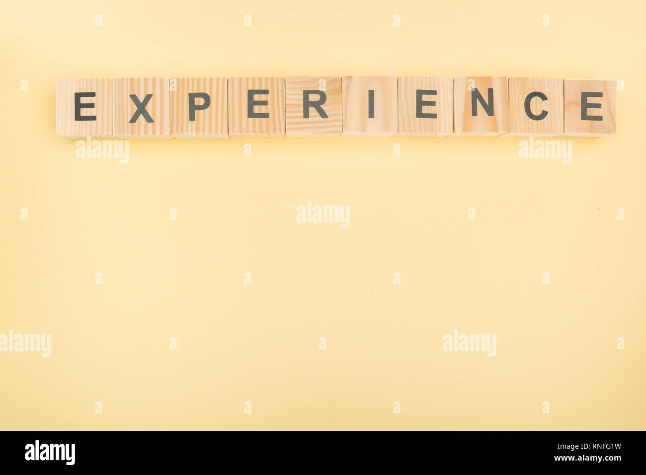top view of experience lettering made of wooden blocks on yellow ...