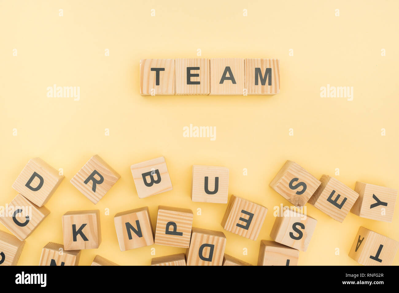 top view of team lettering with wooden cubes on yellow background Stock ...