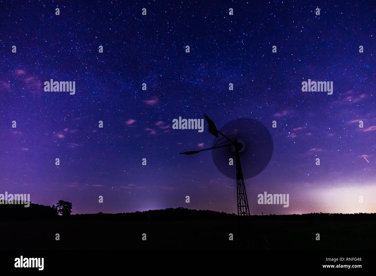 beautiful night photo of wind generators and stars with abstract ...