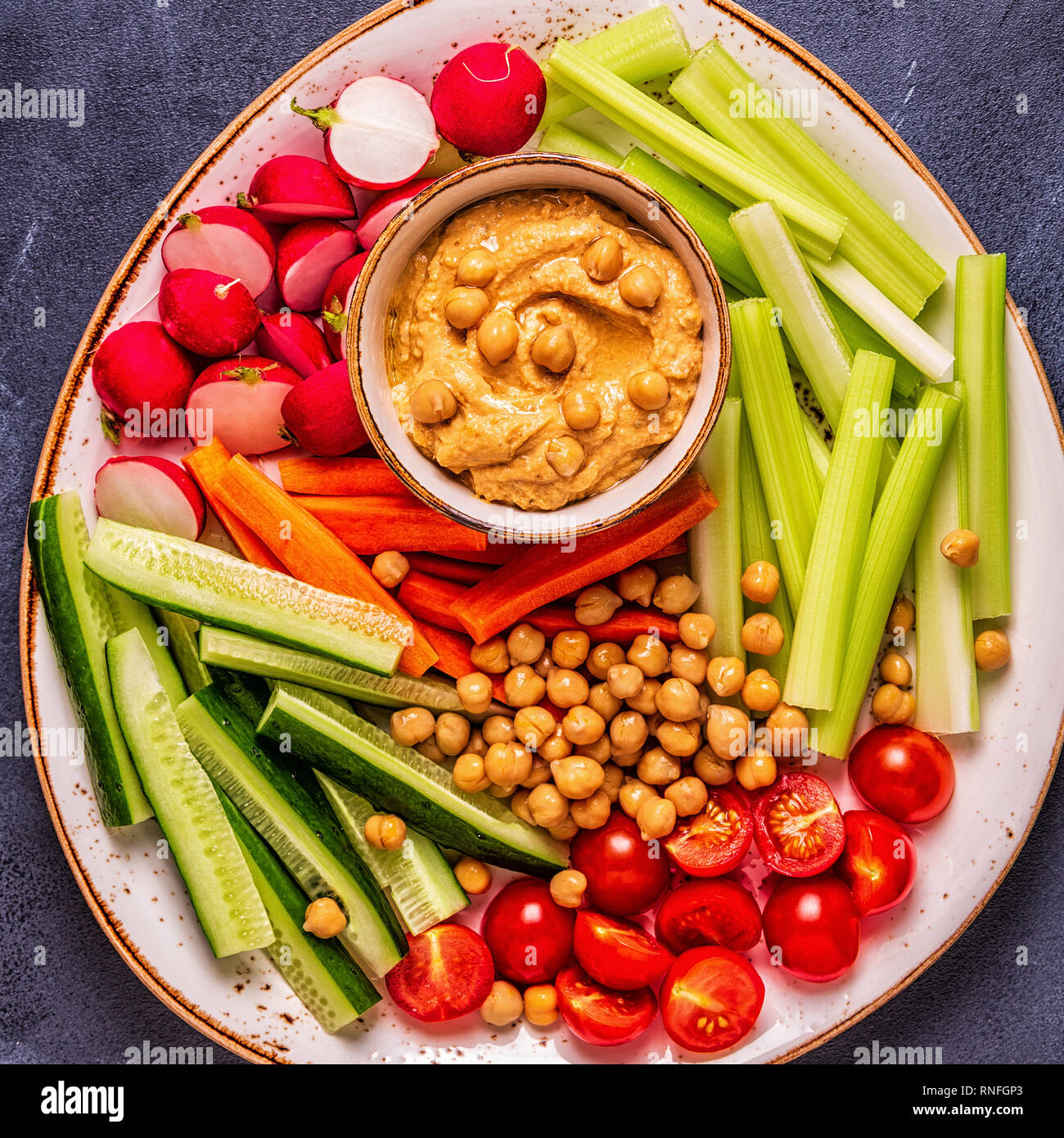Hummus with various fresh raw vegetables, top view Stock Photo - Alamy