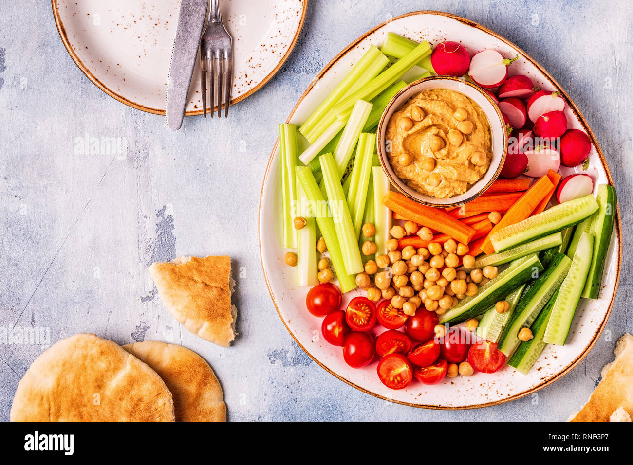 Hummus with various fresh raw vegetables, top view Stock Photo - Alamy