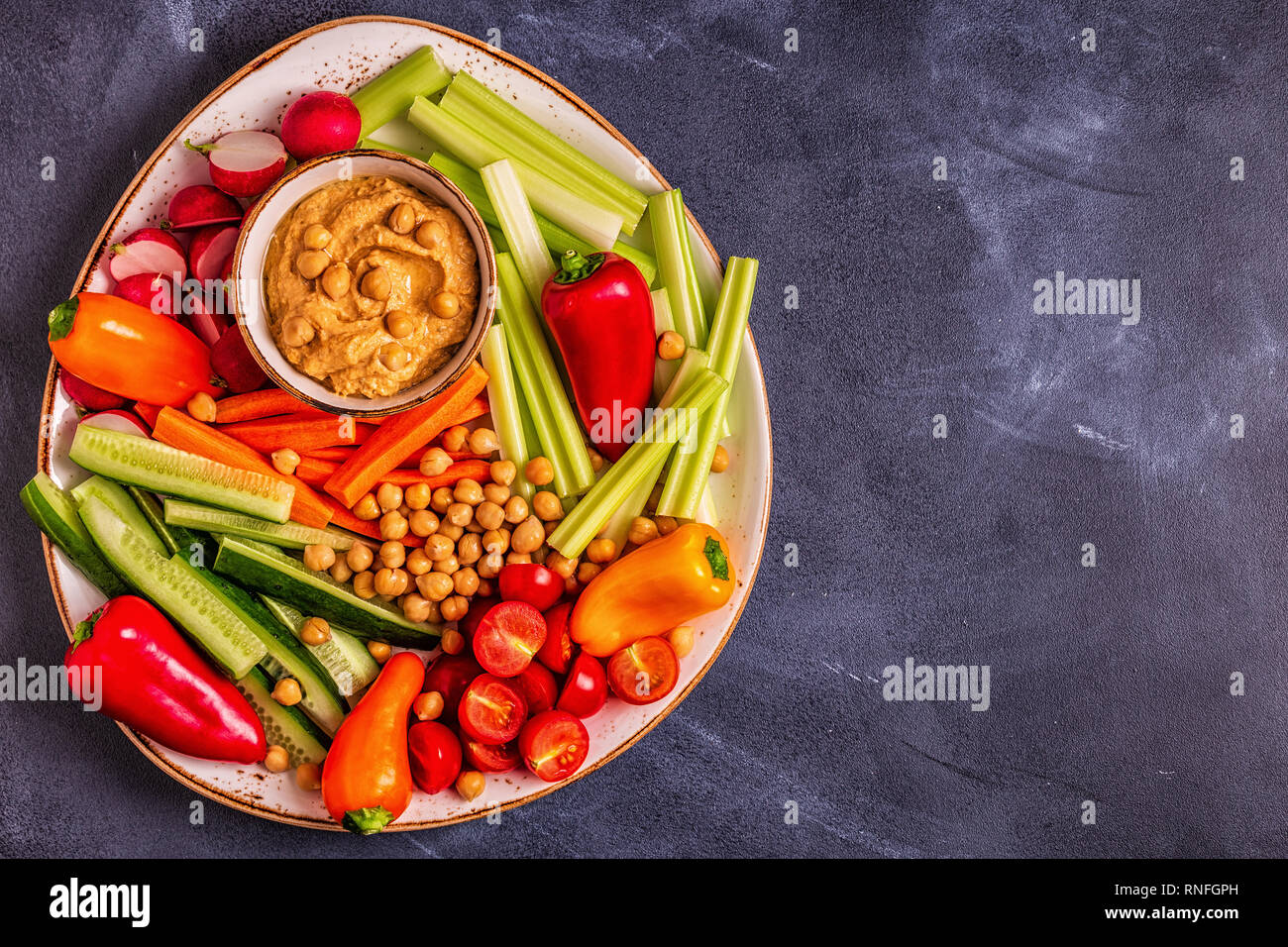 Hummus with various fresh raw vegetables, top view Stock Photo - Alamy