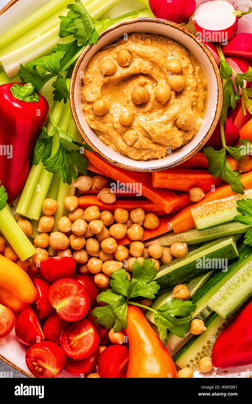 Hummus with various fresh raw vegetables, top view Stock Photo - Alamy