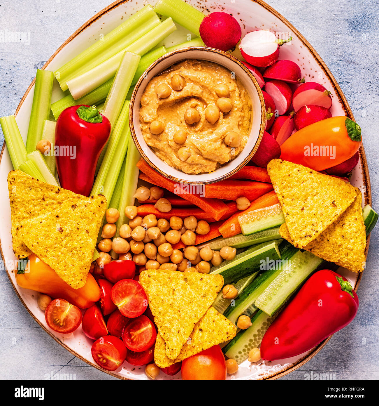 Hummus with various fresh raw vegetables, top view Stock Photo - Alamy