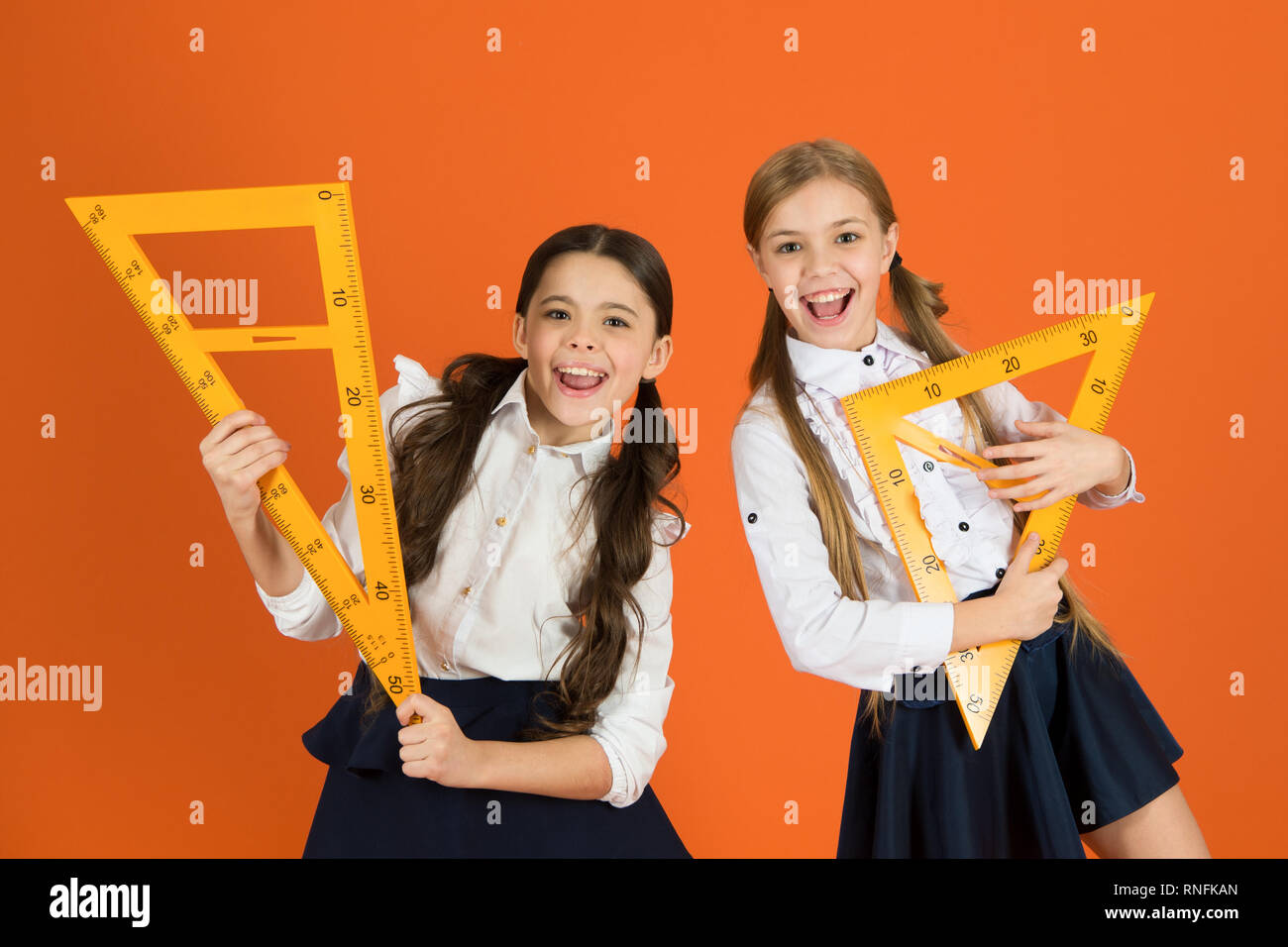 School students learning geometry. Kids school uniform on orange ...