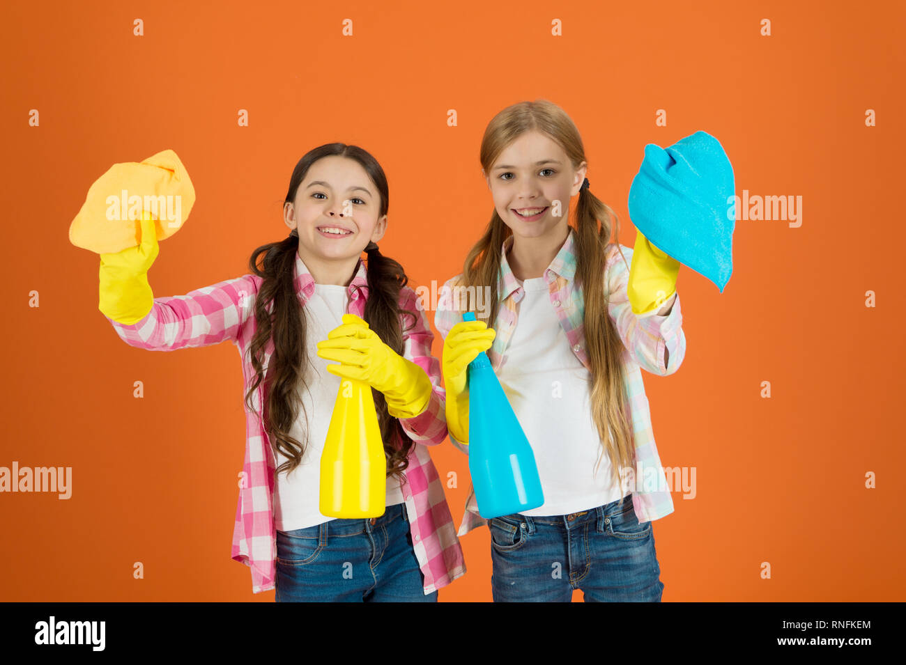 Kids cleaning together. Nice and tidy. Girls with mist spray and rag ...