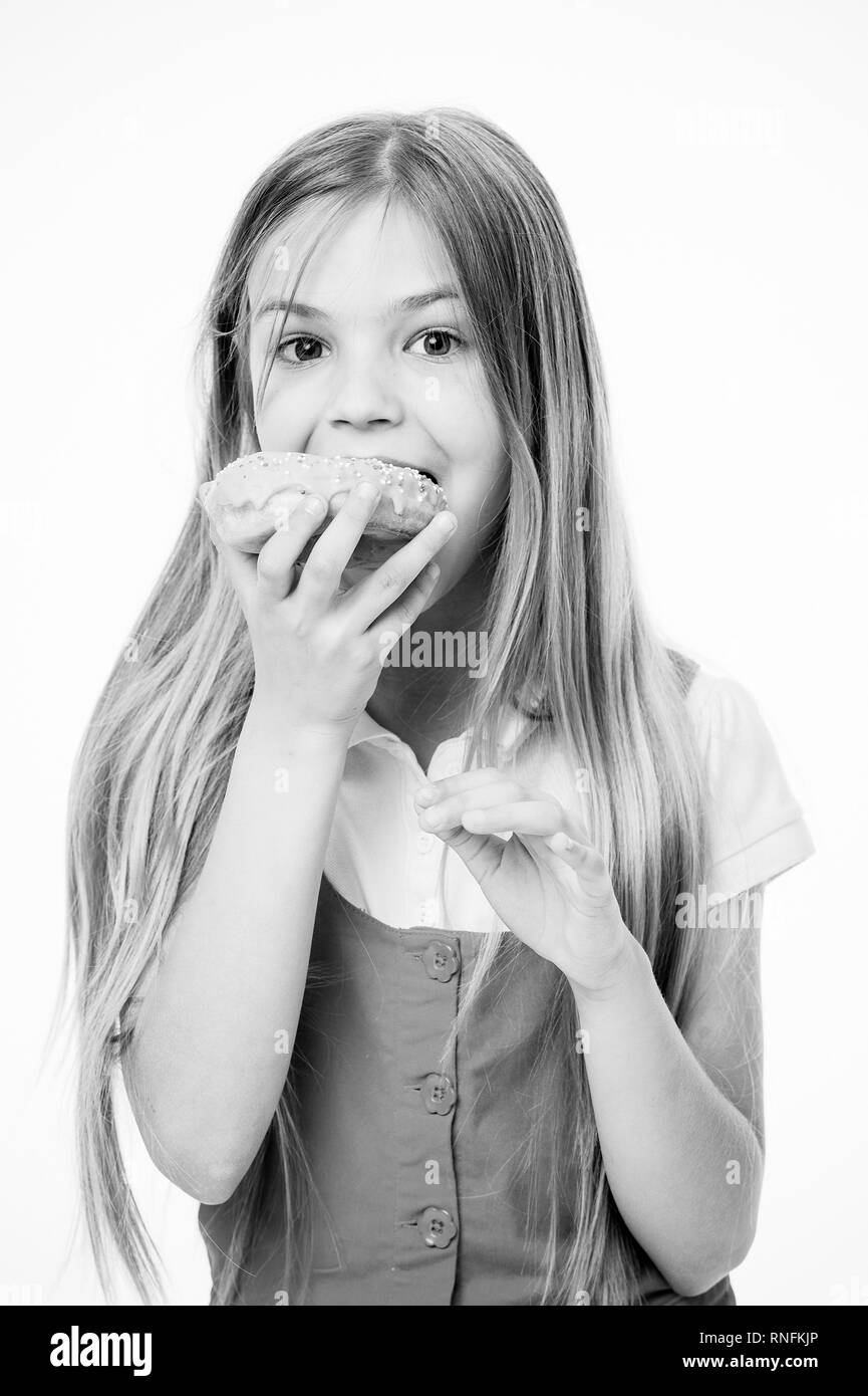 Small girl eating dessert. Happy small girl enjoys sweet dessert. Happy ...