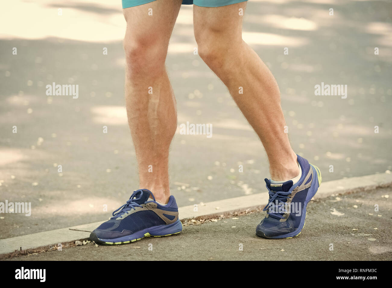 Legs of male athlete runner jogging park sidewalk. Active lifestyle ...