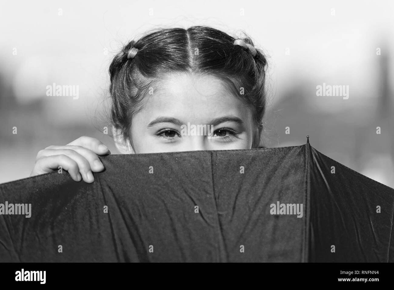 Playing hide and seek. Funny young girl hiding from somebody. Beautiful ...