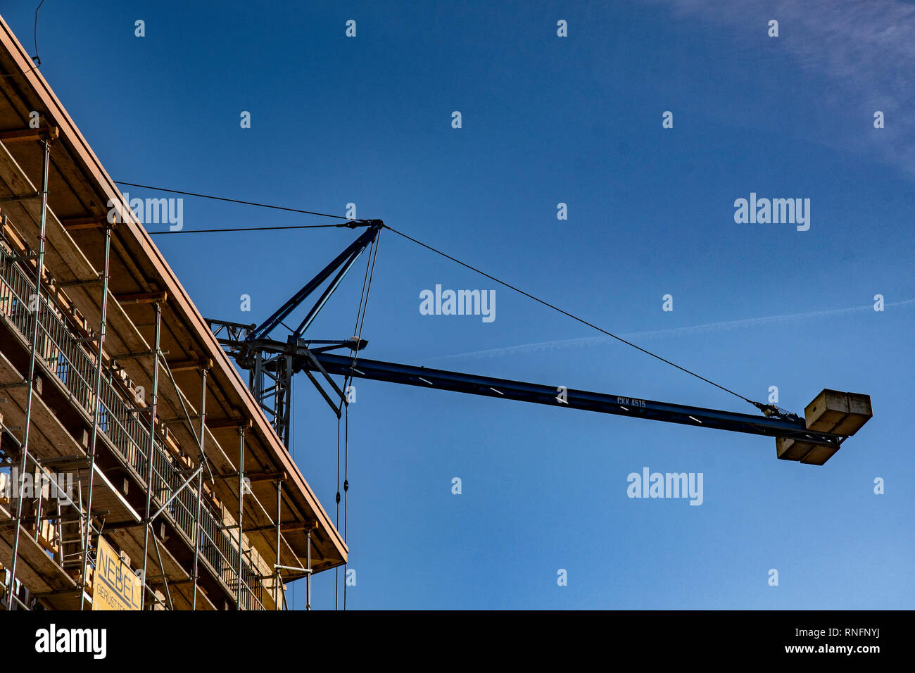 scaffolded house with a crane Stock Photo - Alamy