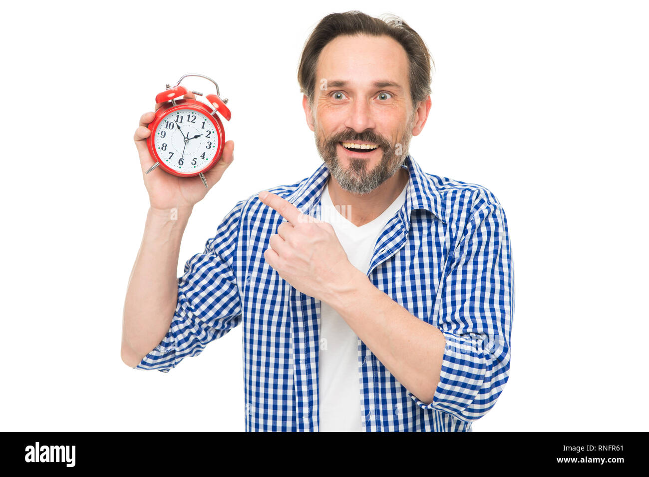 Please observe time. Mature man pointing finger at alarm clock. Mature ...