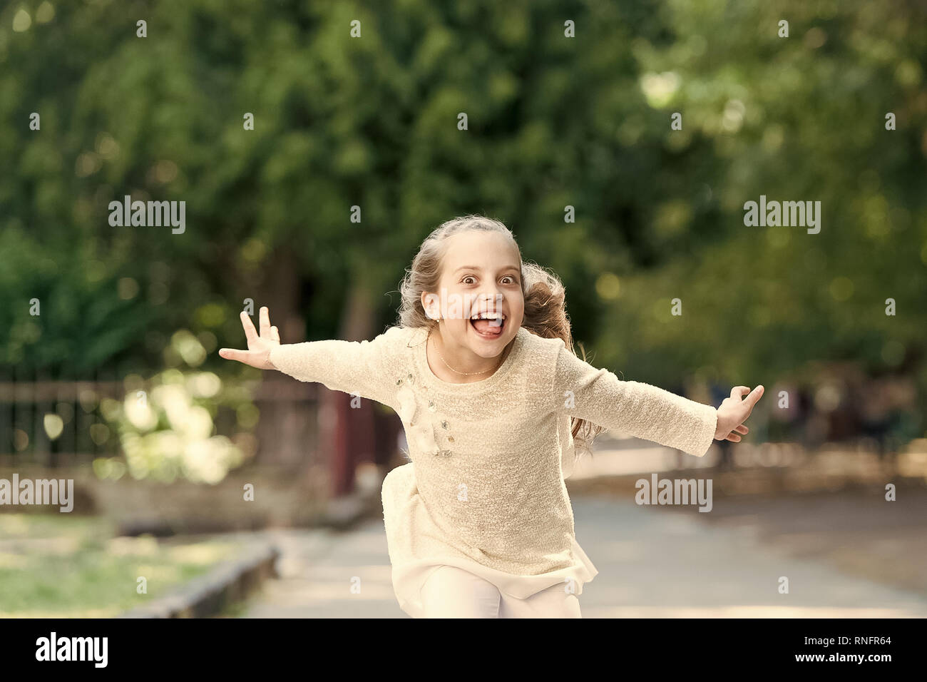 Girl on happy smiling face, nature on background. Child happy and ...