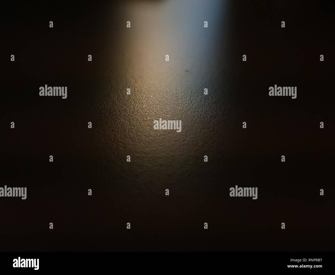 A yellow blue ray of light shining on to a surface Stock Photo - Alamy