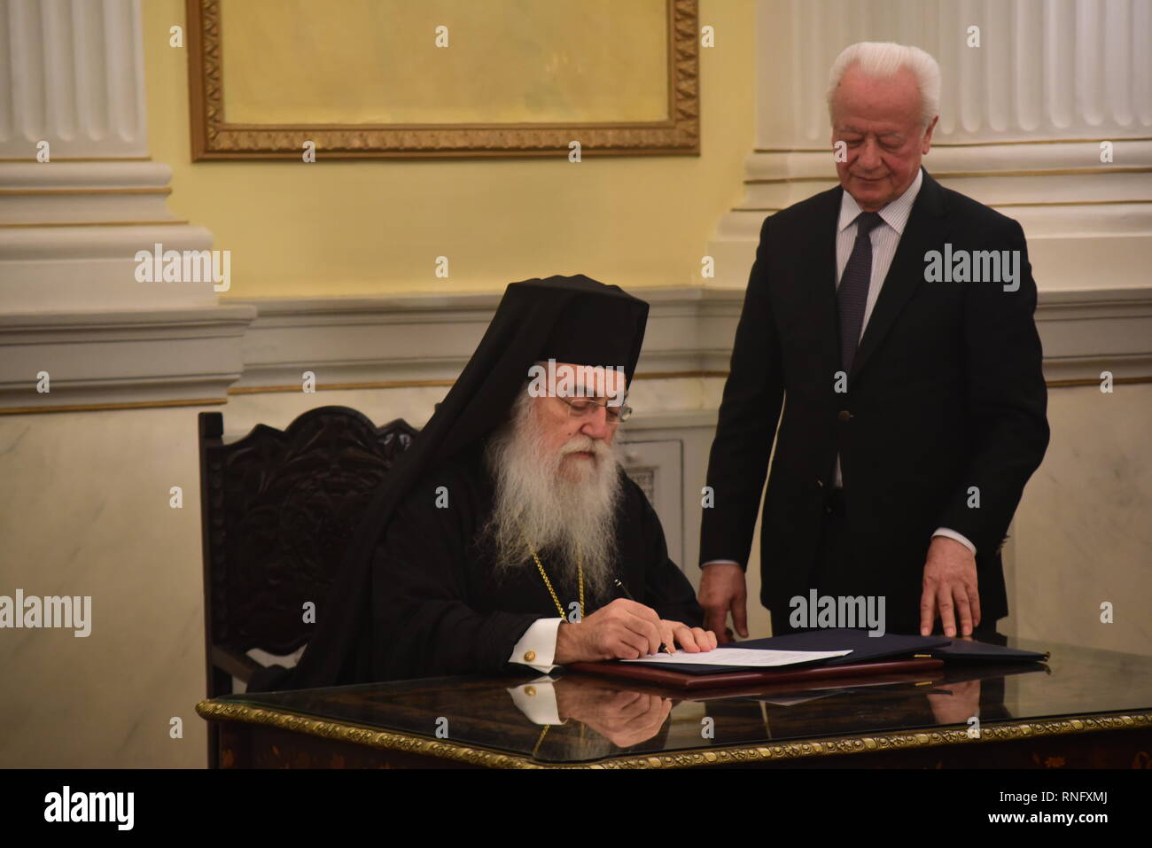 Athens, Greece. 18th Feb, 2019. Bishop of Methoni, Mr. Klimis, signs ...