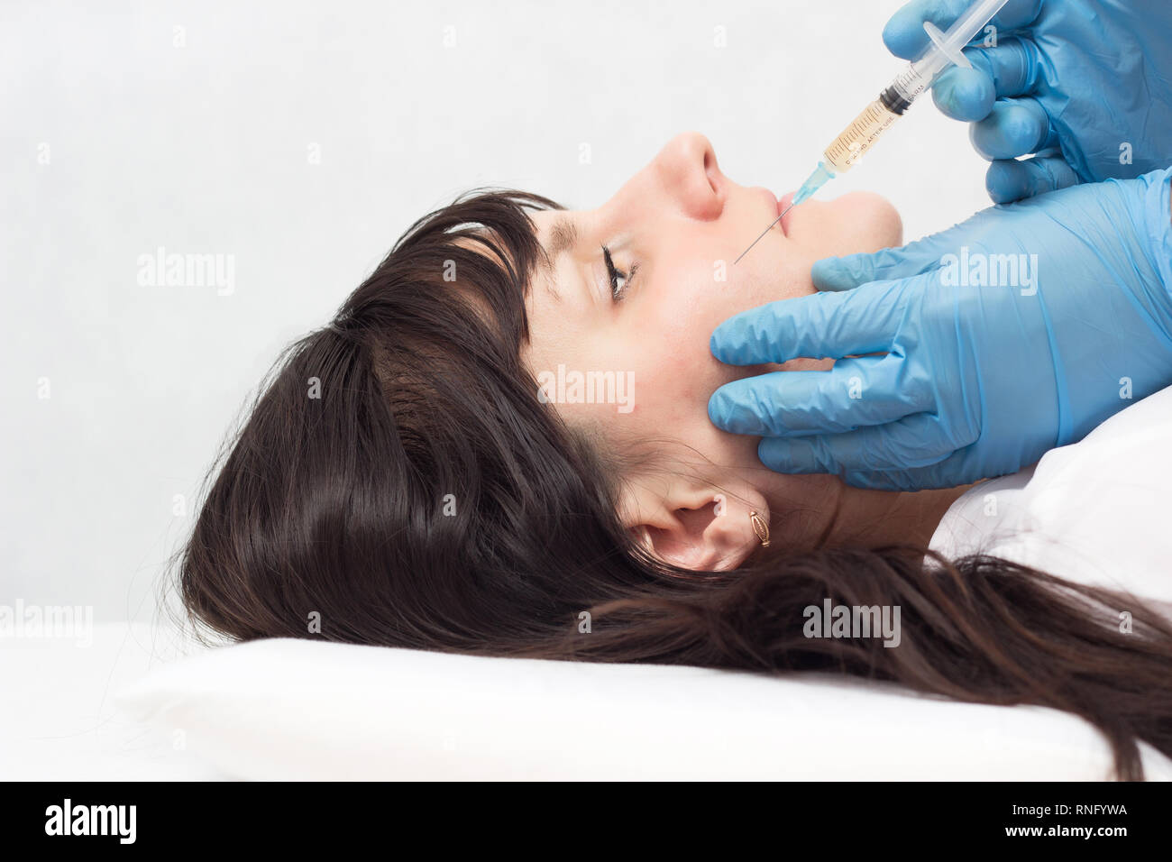 Doctor makes plasma-lifting injection to a young girl in the face ...