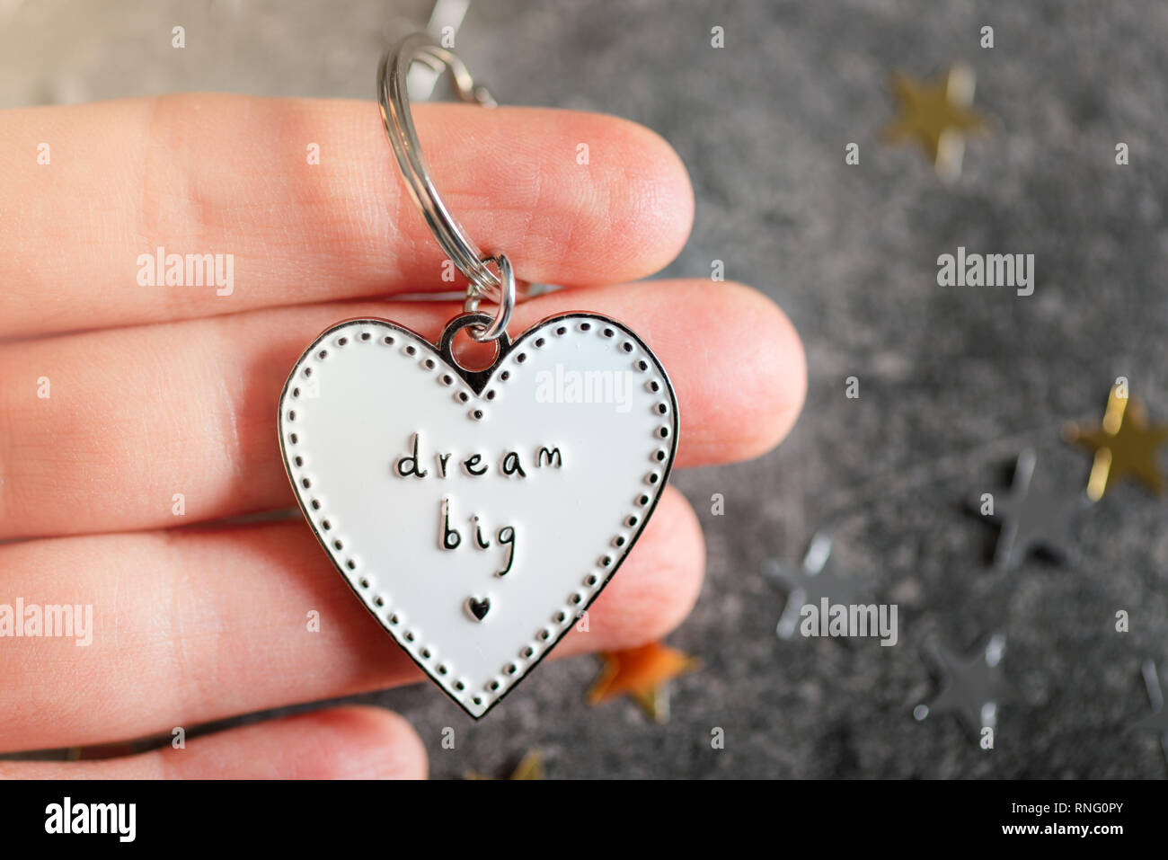 Keyring in the shape of heart and slogan DREAM BIG. Minimalist Concept ...
