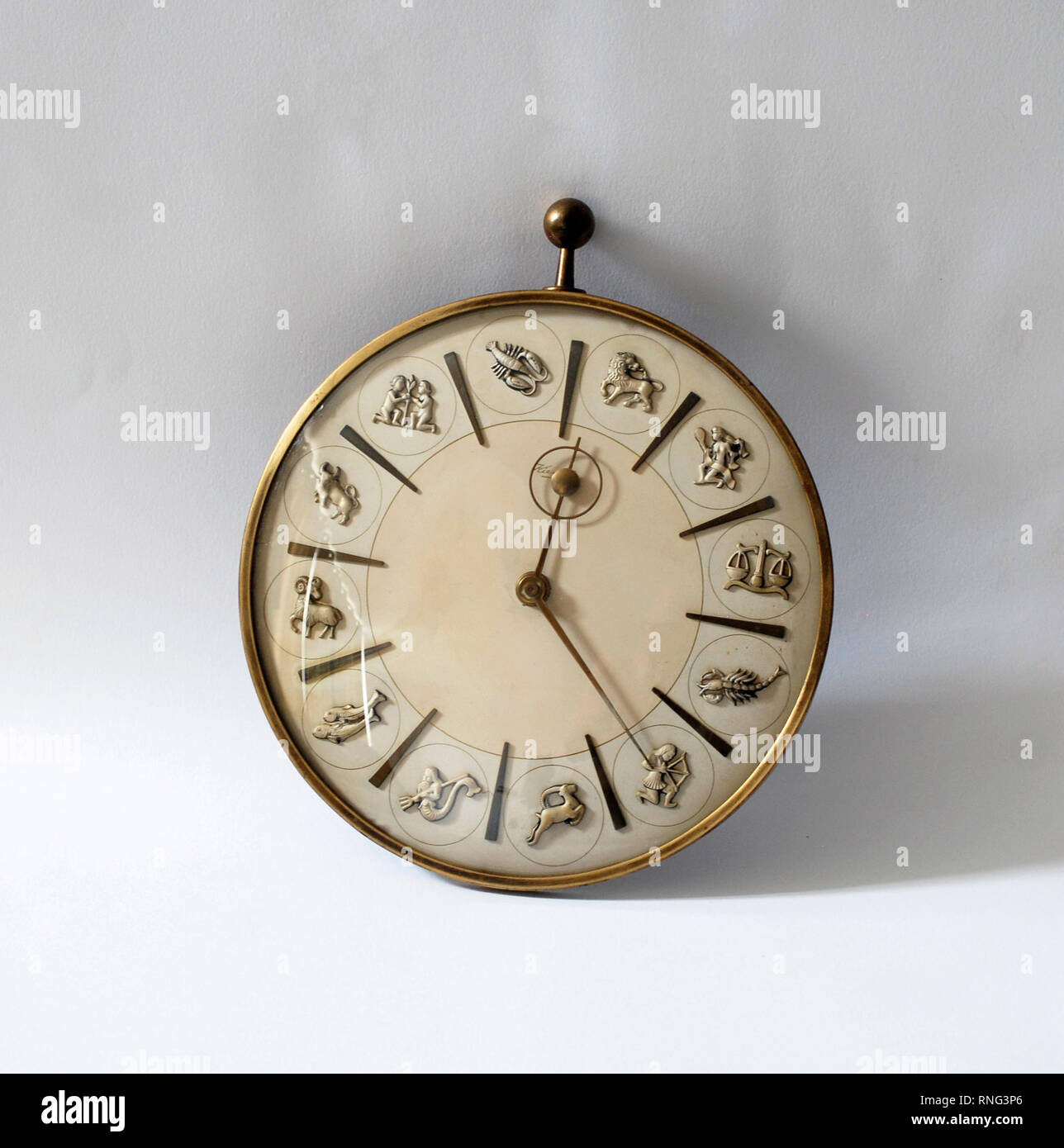 Old bronze clock with the signs of the sodiac Stock Photo - Alamy