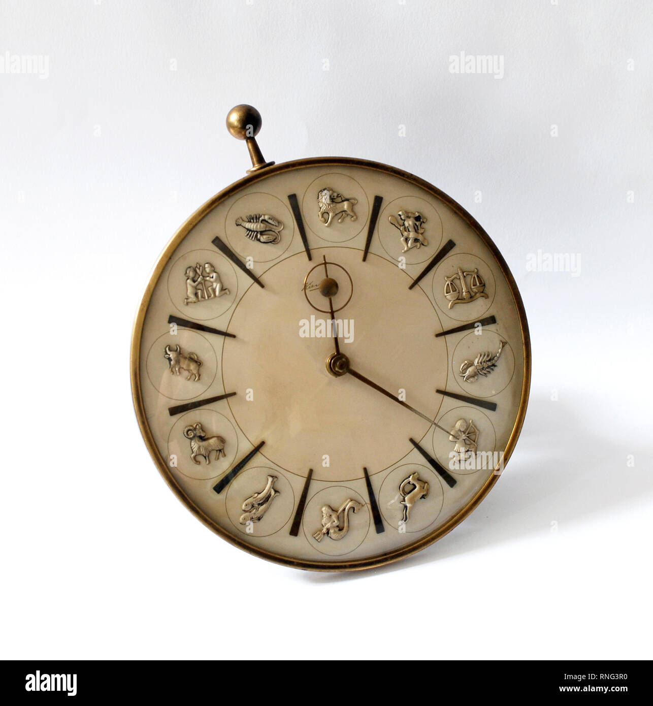 Old bronze clock with the signs of the sodiac Stock Photo - Alamy