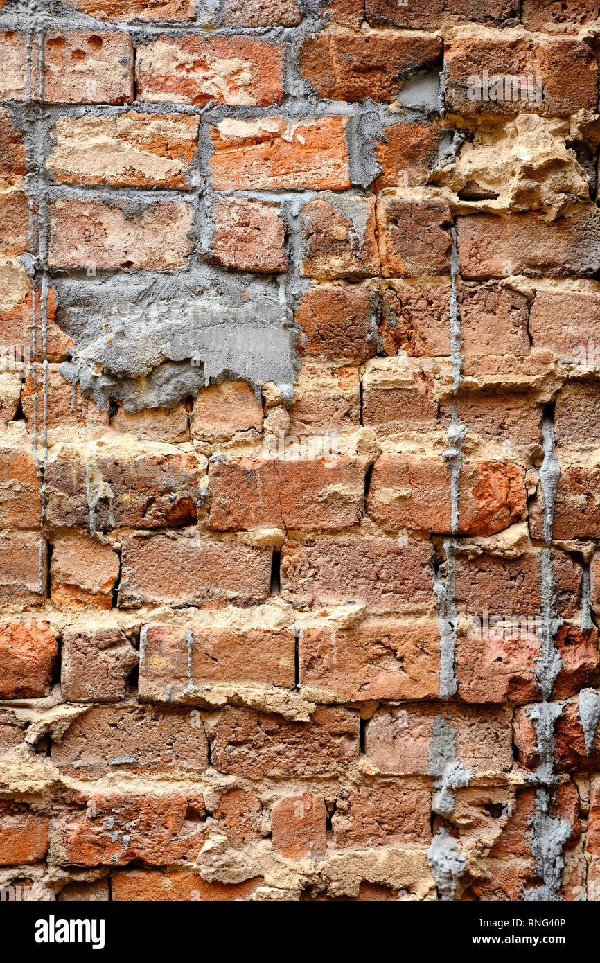 Old weathered cracked and damaged brick background in a pattern with ...