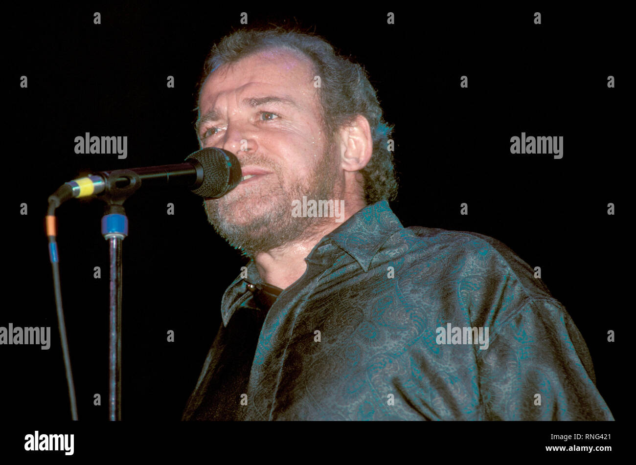 English rock and blues singer Joe Cocker is shown on stage performing ...