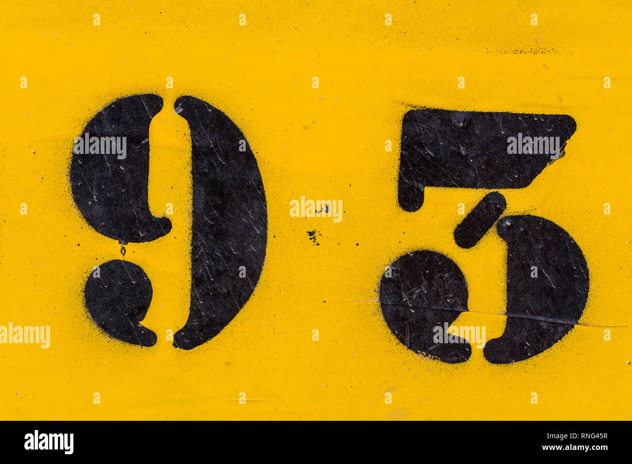 black number stencil painted on yellow background, number 93, number ...